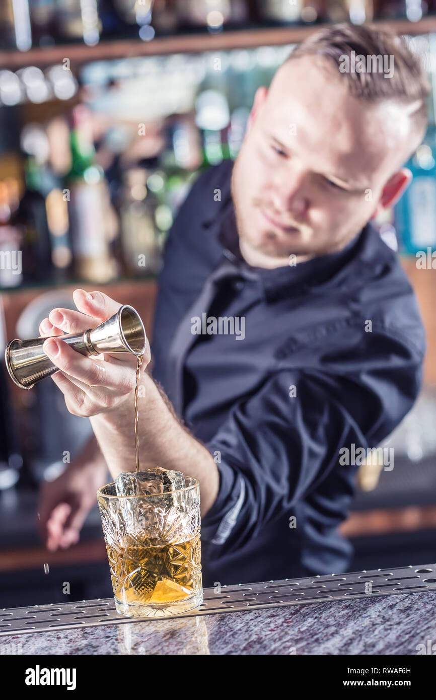 Professional barman making alcoholic cocktail drink old fashioned Stock ...