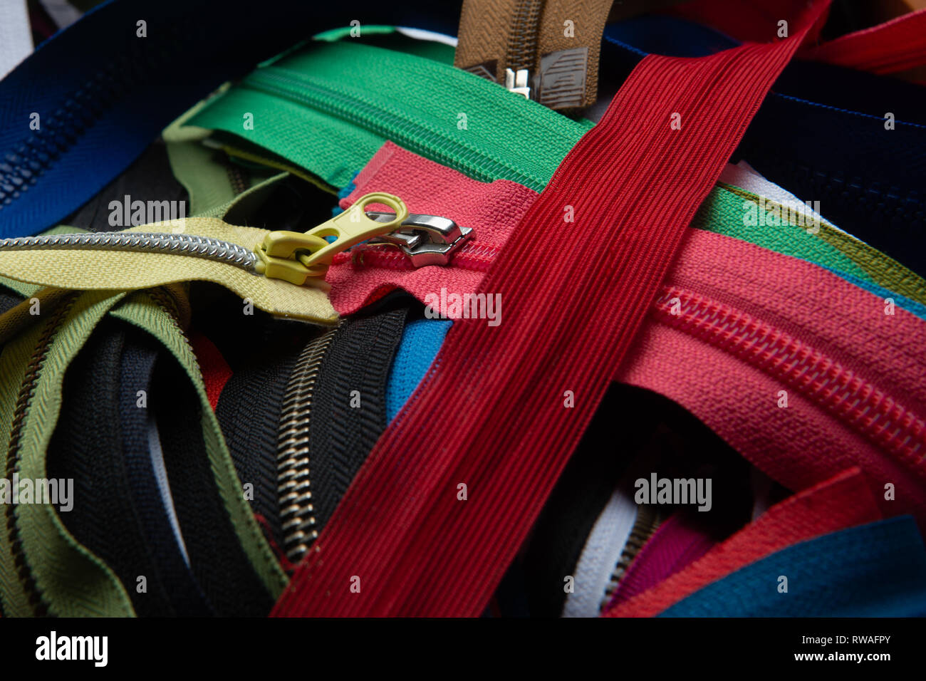 Bunch of multicolored zippers Stock Photo - Alamy