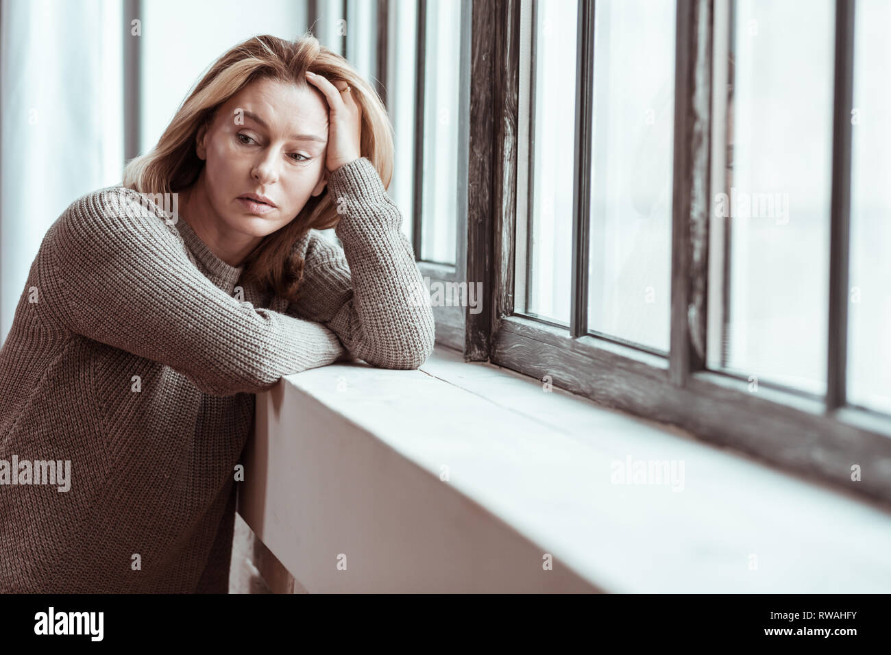 Pleasant woman feeling thoughtful having personal problems Stock Photo ...