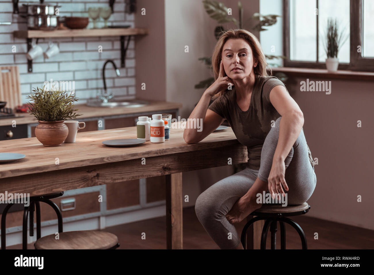 Blonde woman sweating while feeling sick and stressed Stock Photo - Alamy