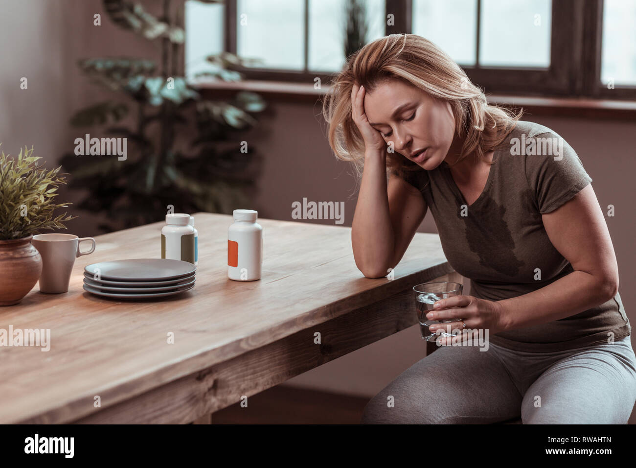 Stressed woman sweating and feeling awful after panic attack Stock ...