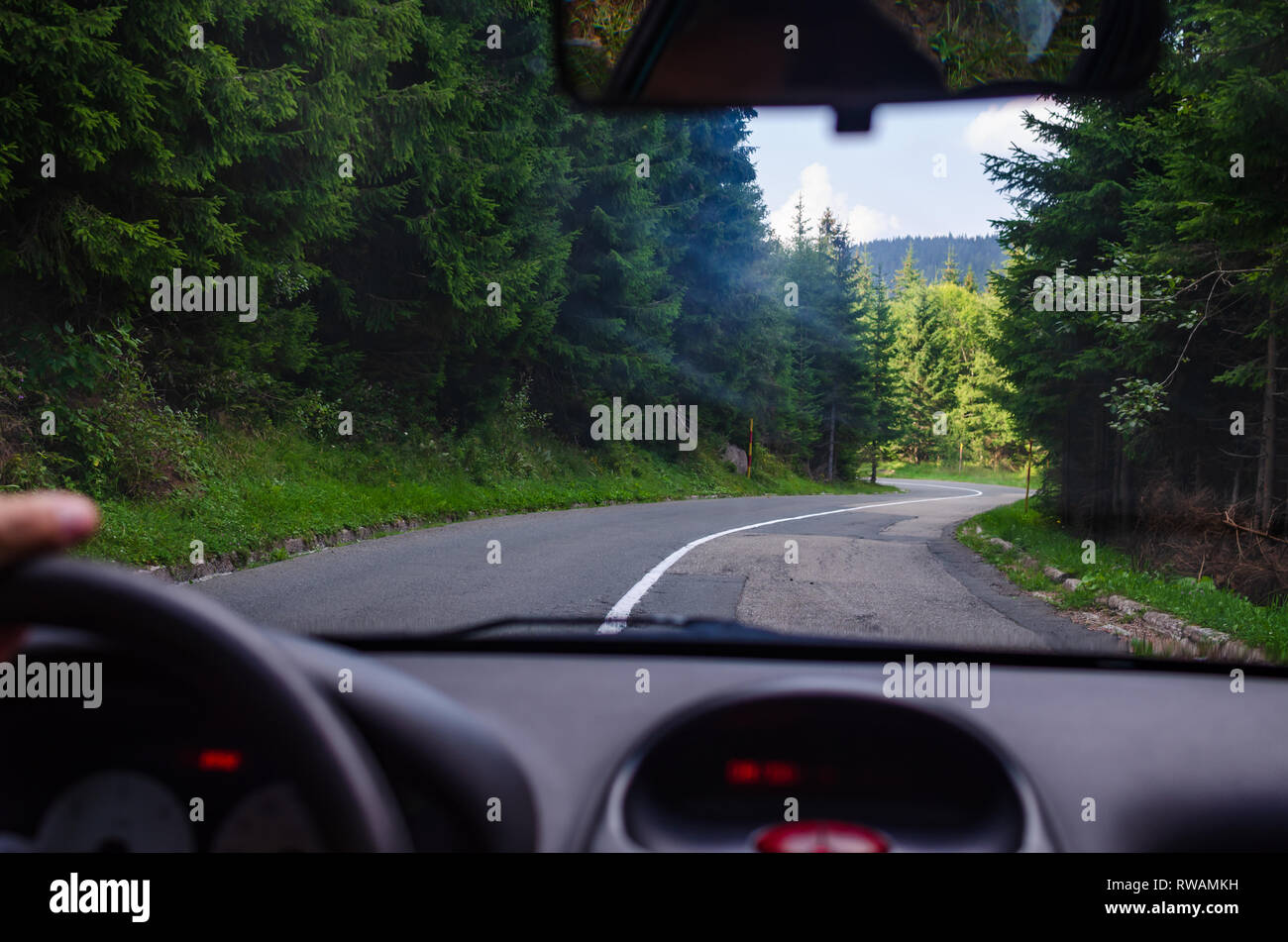 Driving on a road that goes through a picturesque countryside in ...