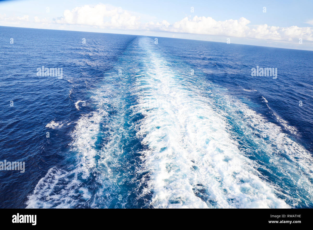 Trail on water surface behind of cruise ship Stock Photo - Alamy