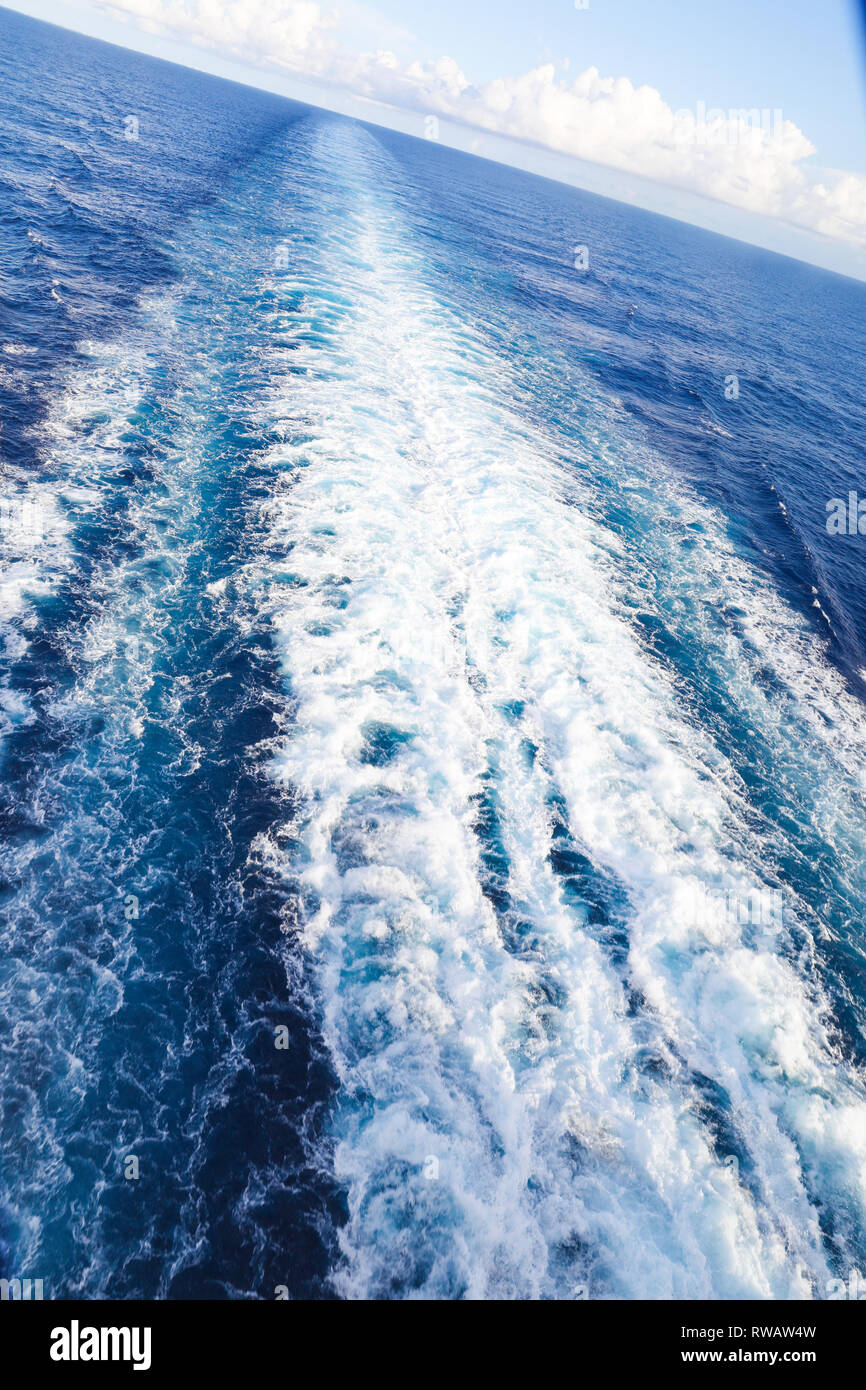 Trail on water surface behind of cruise ship Stock Photo - Alamy