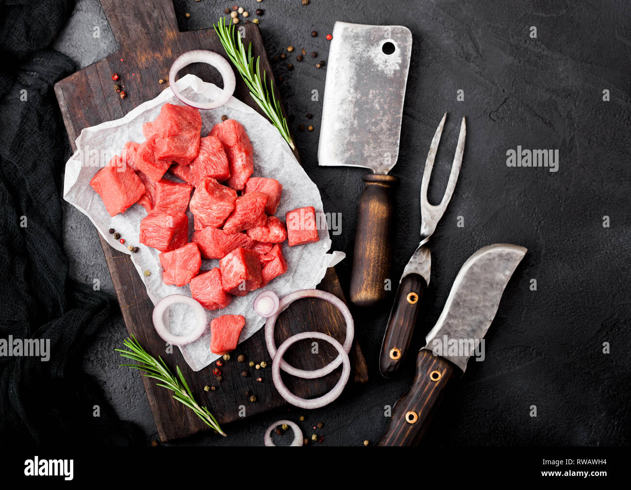 Raw lean diced casserole beef pork steak with vintage meat hatchet and ...
