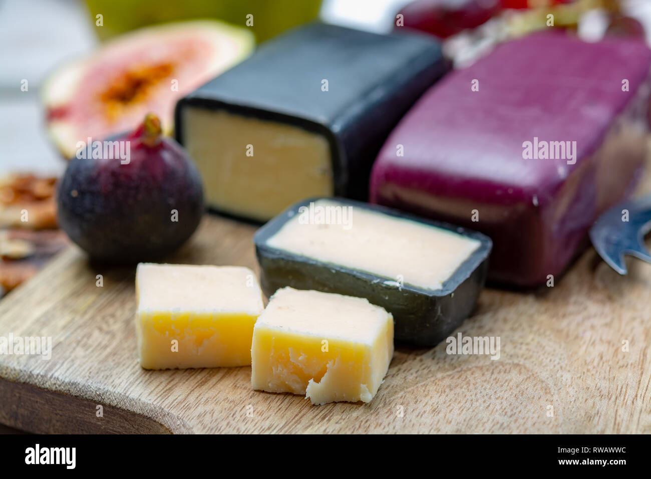 Mini black and dark red waxed cheddar cheeses made from West Country ...