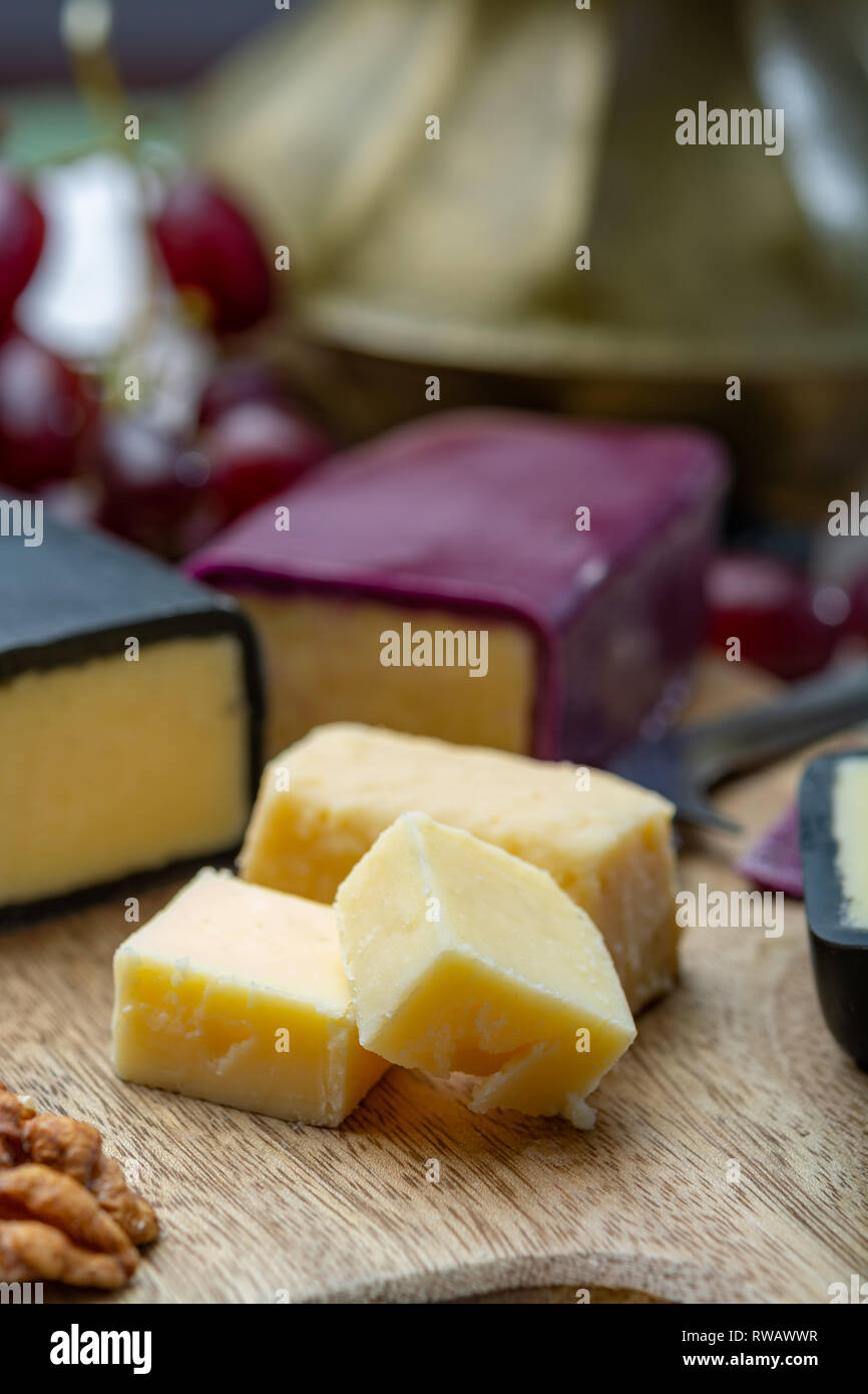 Mini black and dark red waxed cheddar cheeses made from West Country ...