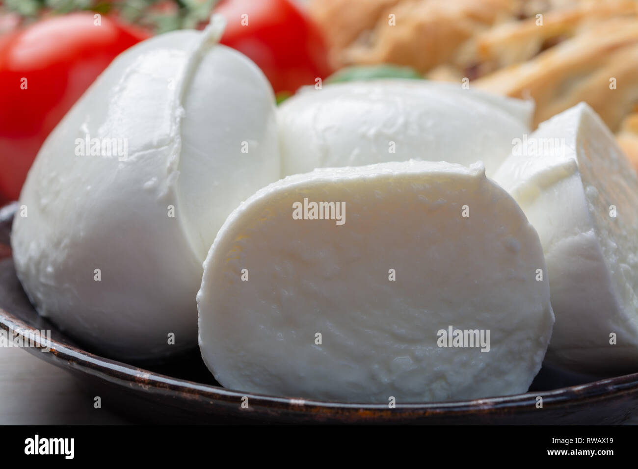 Balls and pieces of buffalo mozzarella, soft Italian scheese made from ...
