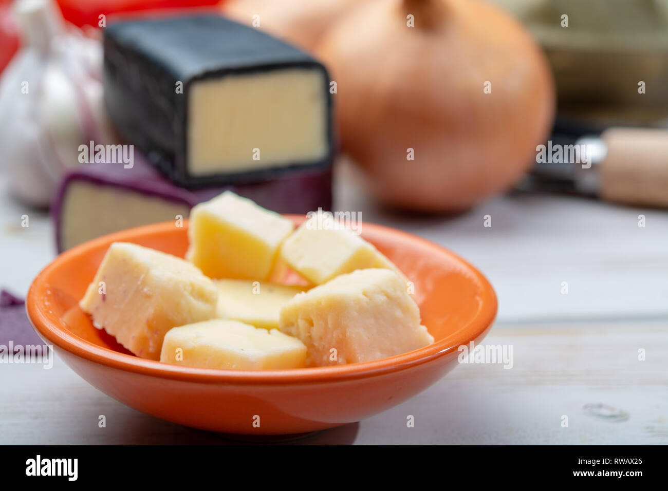 Mini black and dark red waxed cheddar cheeses with strong flavor made ...