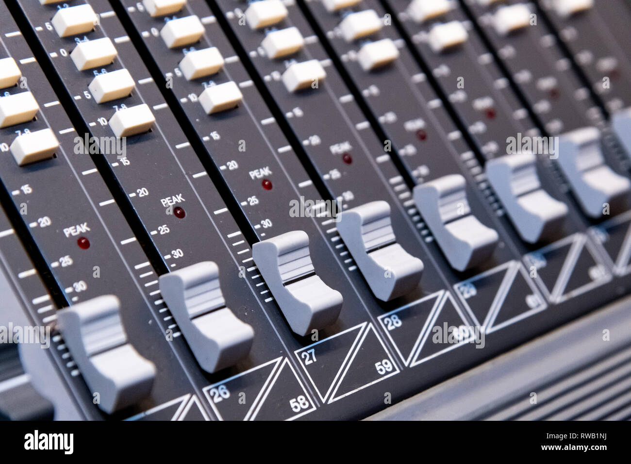 Abstract view of Professional audio mixing console with faders and ...