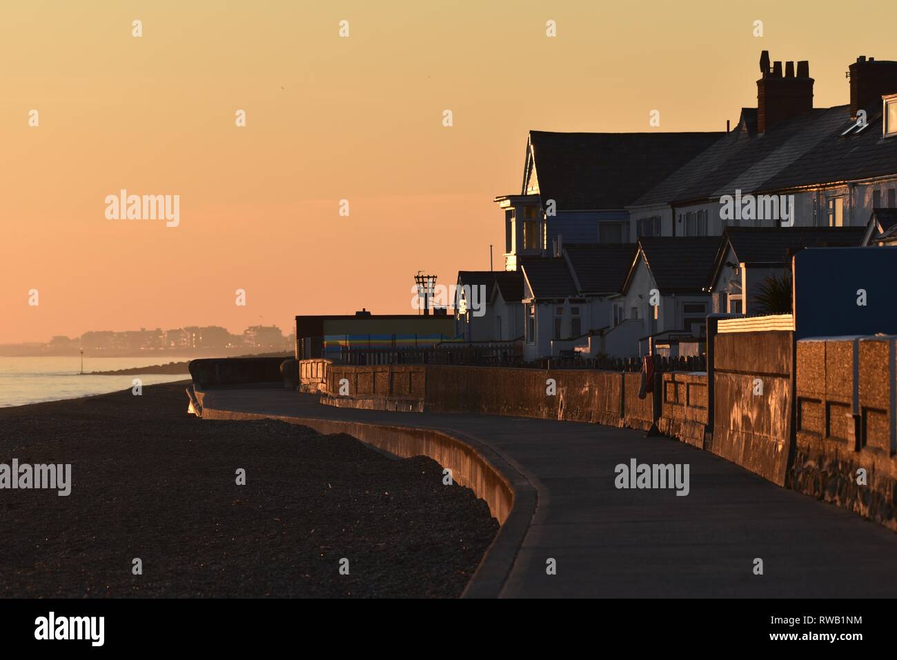 In the foreground Sandgate esplanade, in the background Hythe at sunset ...