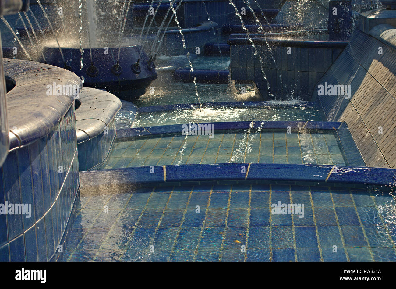 Fountain made of blue ceramic tiles with water splashing around Stock ...