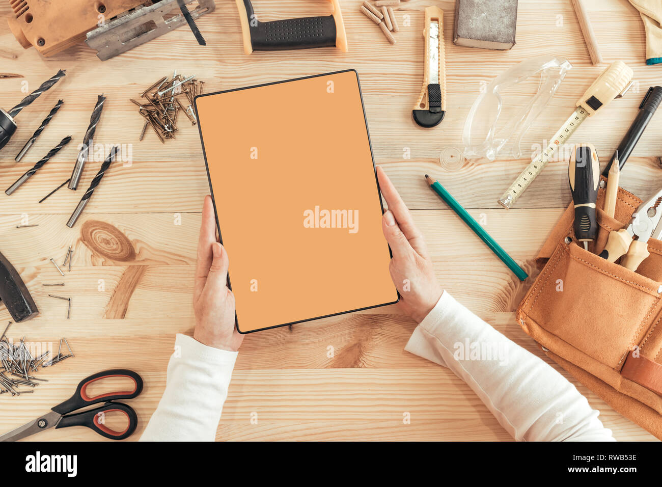 Female carpenter using digital tablet computer in woodwork workshop ...