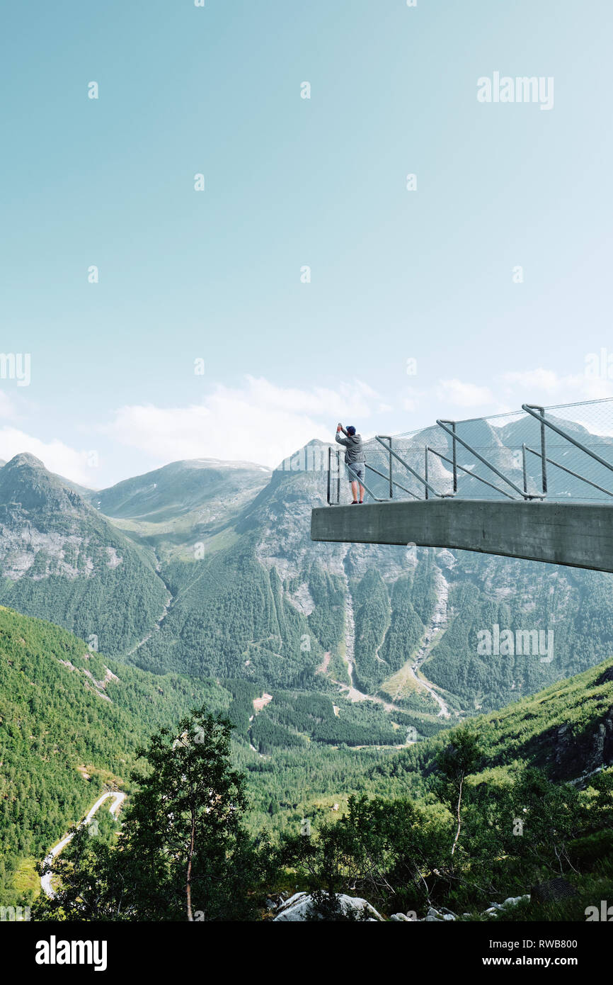 A tourist on the viewpoint at Utsikten offering fine views of the ...