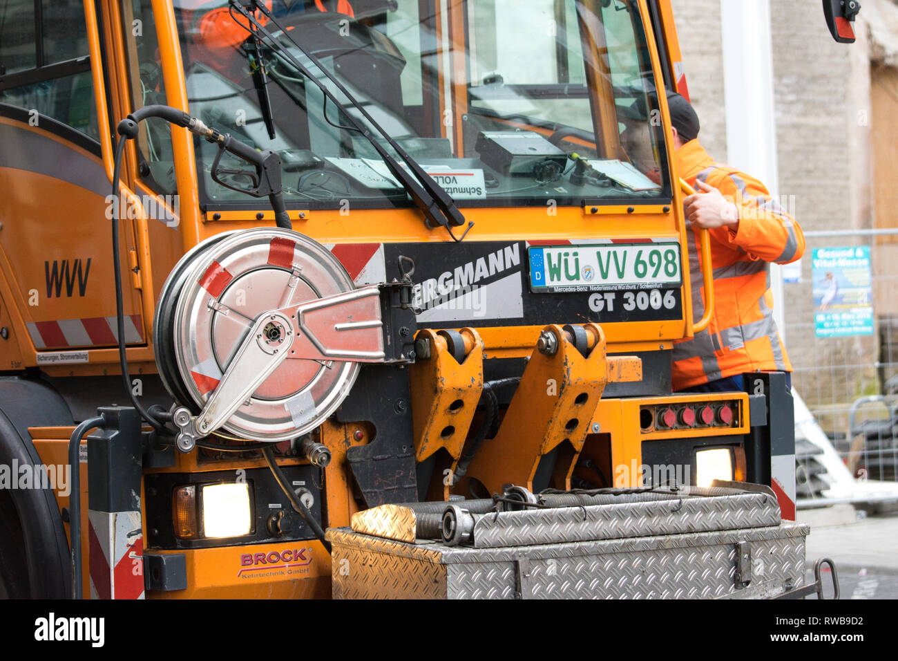 street cleaning workers and vehicles in the city Germany Wurzburg. the ...