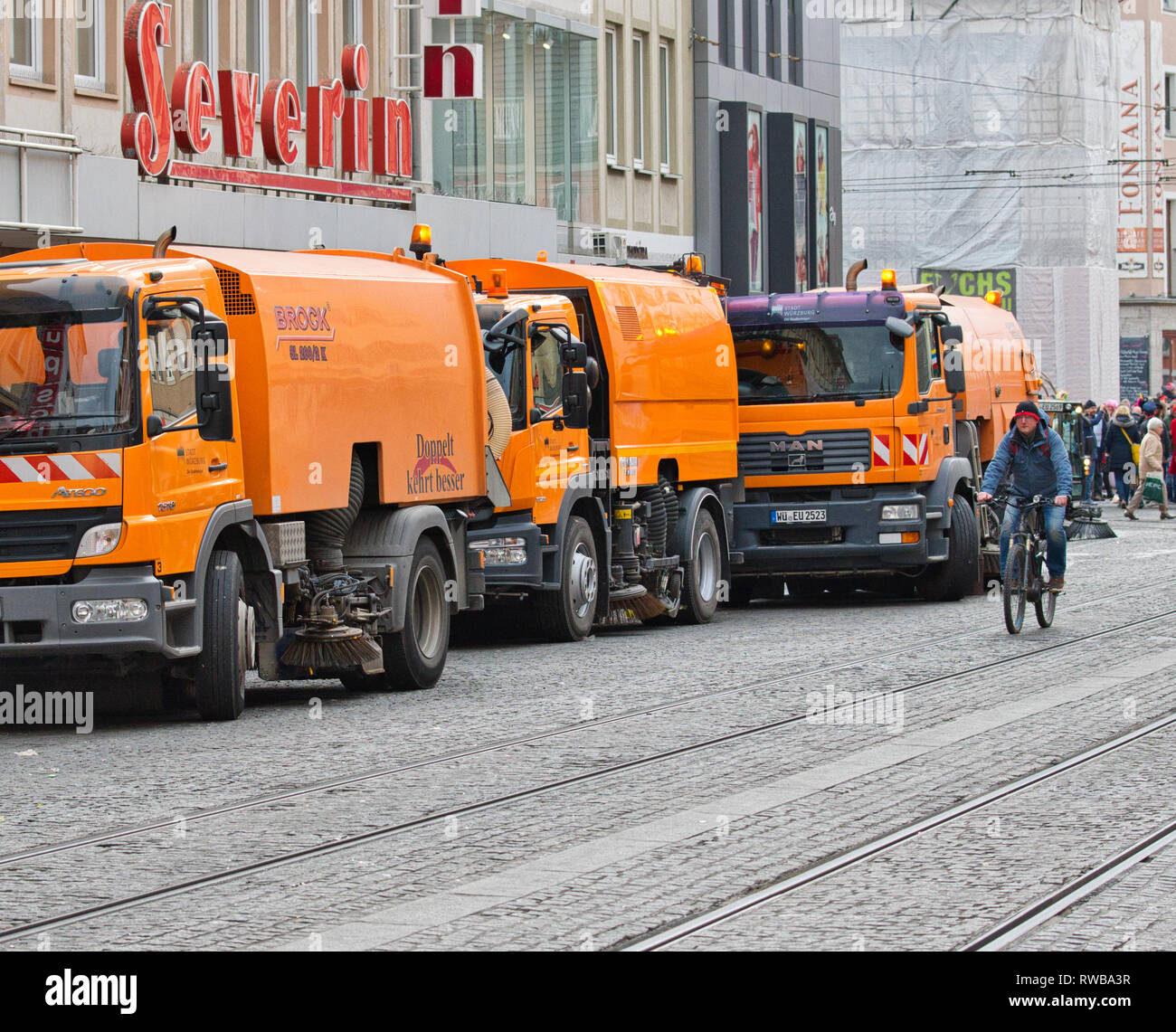 street cleaning workers and vehicles in the city Germany Wurzburg. the ...