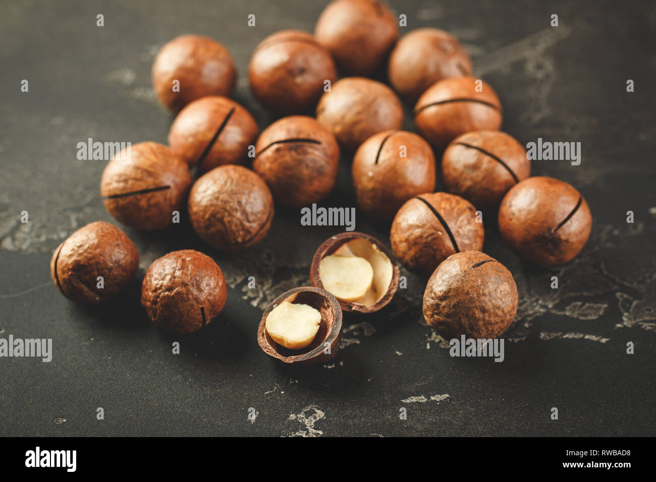 Organic Macadamia nuts in on dark cocrete background close up Stock ...