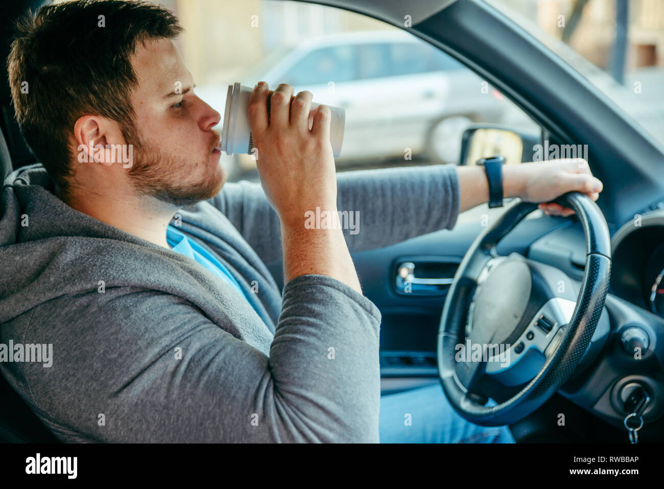 man driving car and drinking coffee. lifestyle. road trip Stock Photo ...