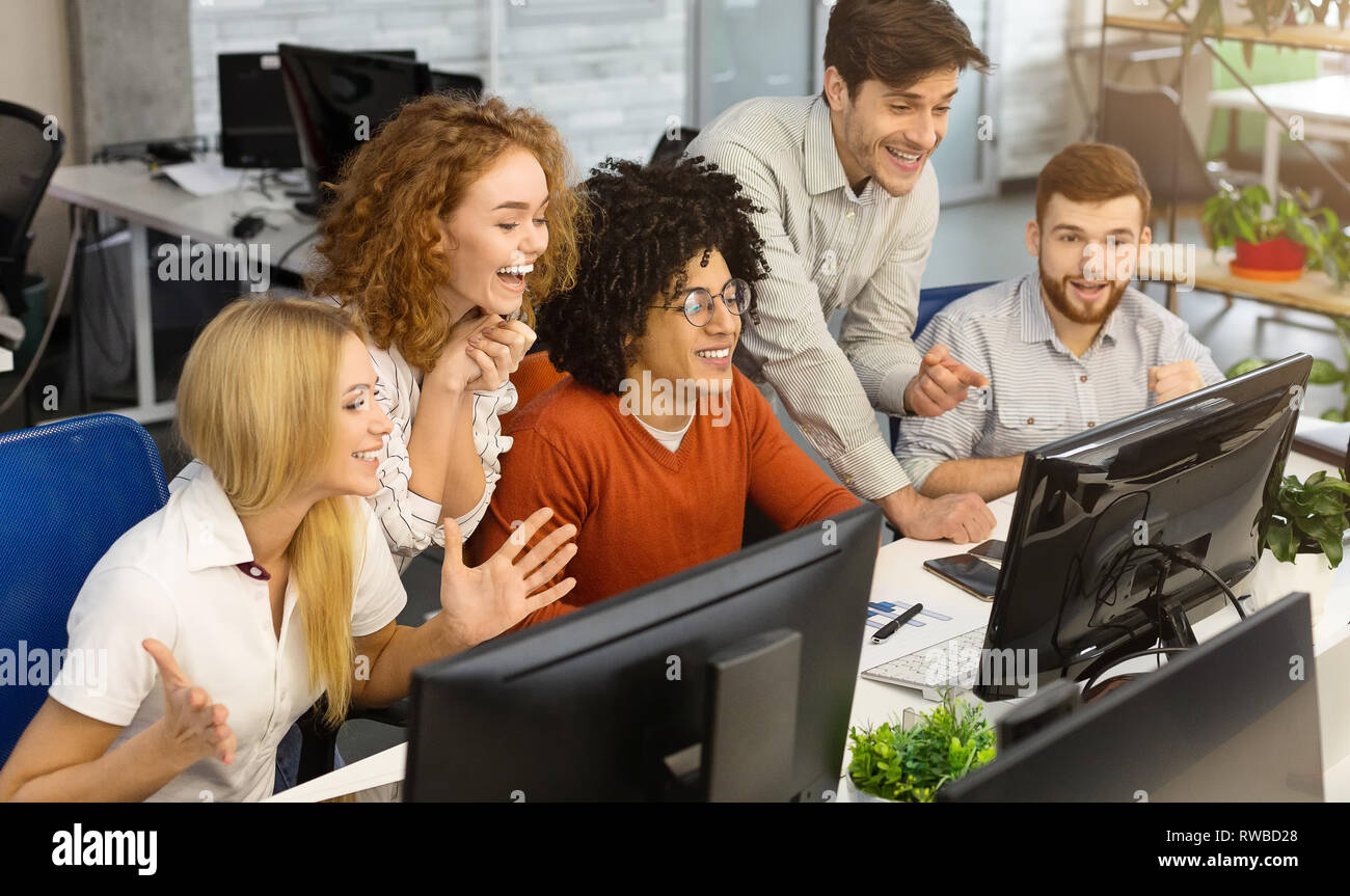 Business team looking at screen of computer celebrating victory Stock ...