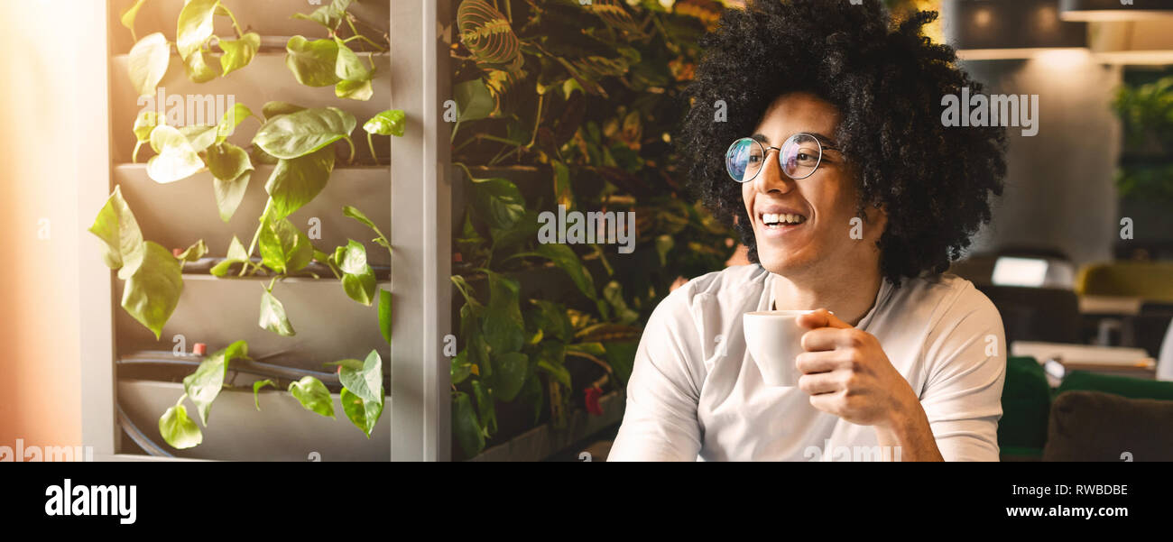 African-american millennial guy enjoying coffee in modern cafe Stock ...