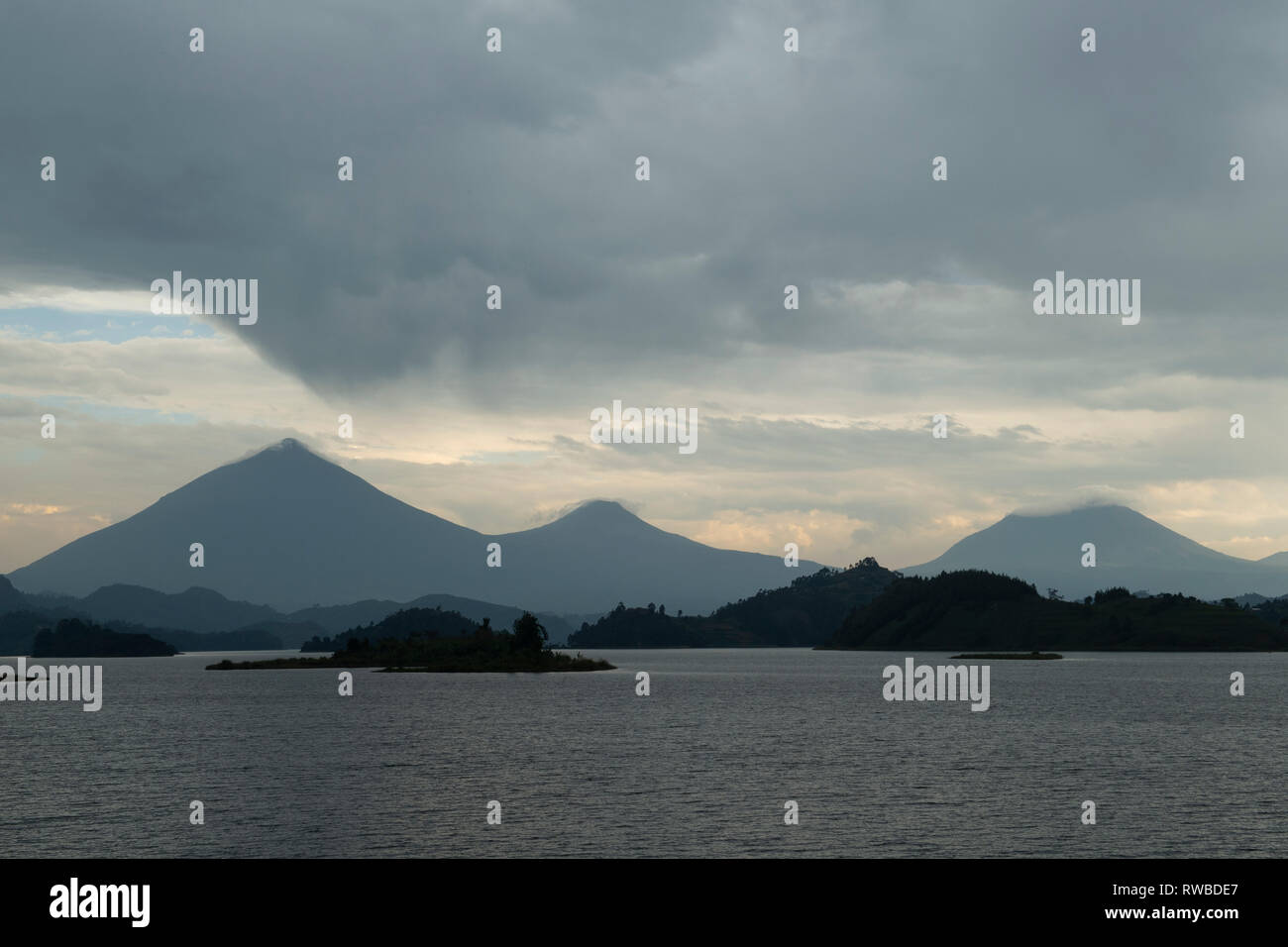 Lake Mutanda with views of volcanoes of the Virunga Mountains, Uganda ...