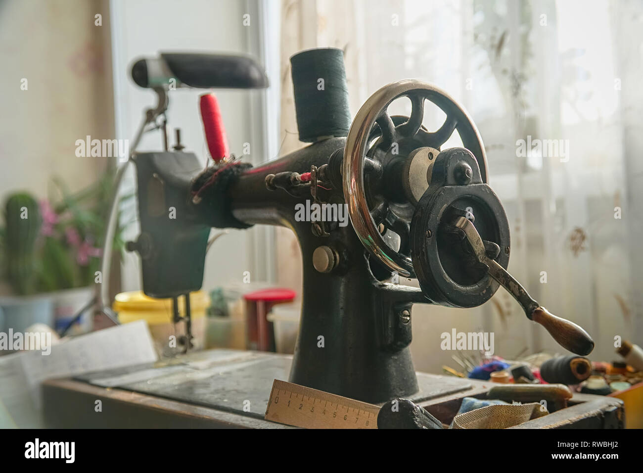 Old mechanical sewing machine on table Stock Photo - Alamy