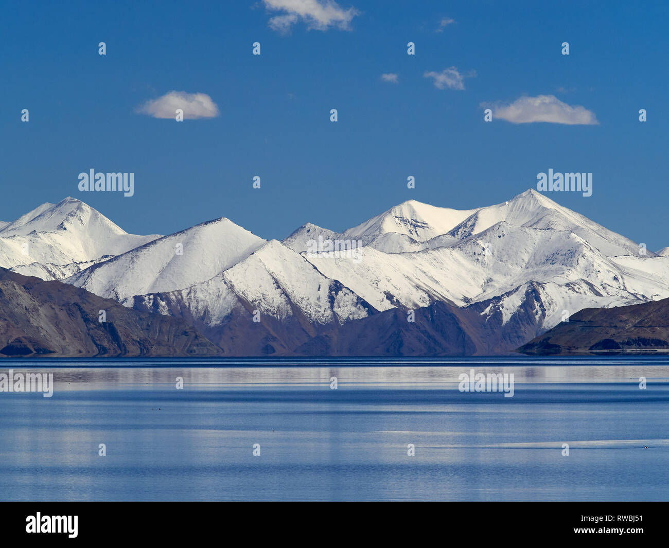 Lake Pangong, blue expanse of water and mountains from the snow on the ...