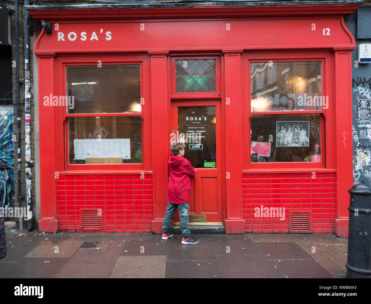 Boy outside sweet shop Stock Photo - Alamy