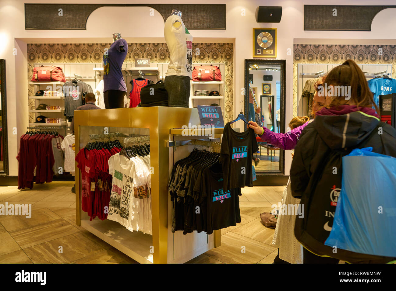ROME, ITALY - CIRCA NOVEMBER, 2017: women choose T-Shirt at Rock shop ...