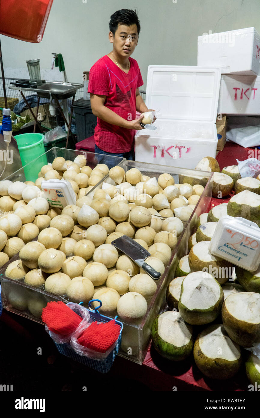 Singapore - January 28, 2019 : - Vendors selling fresh young coconuts ...