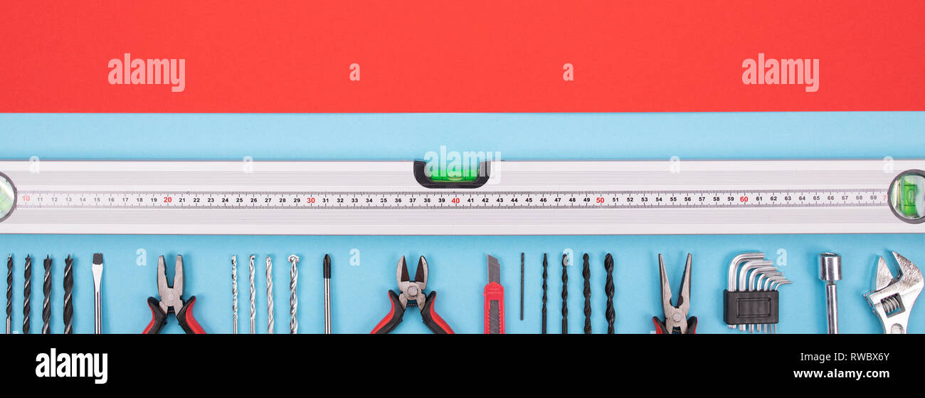 Set of construction tools on red-blue background Stock Photo - Alamy