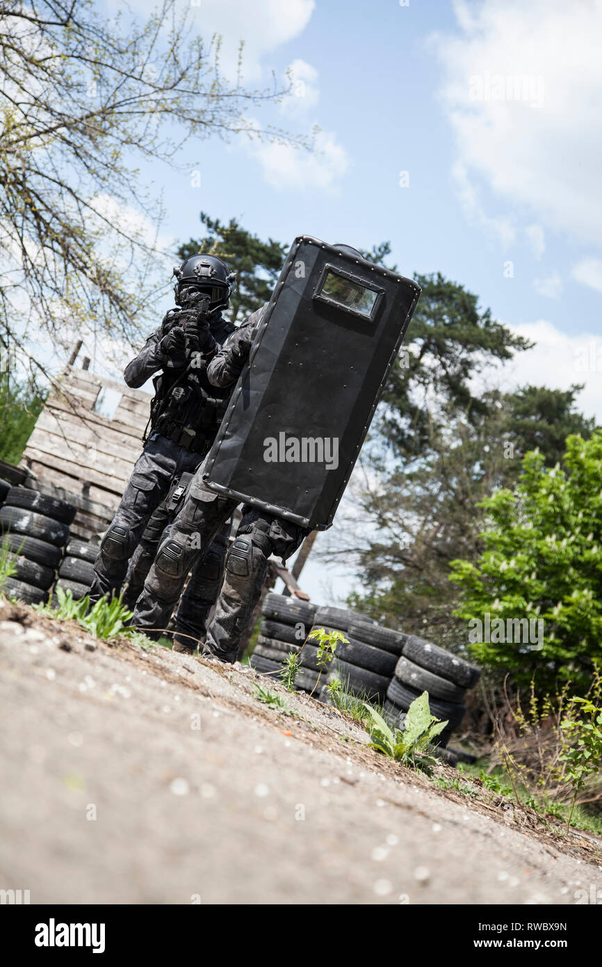 Spec ops police officers SWAT in black uniform in action Stock Photo ...