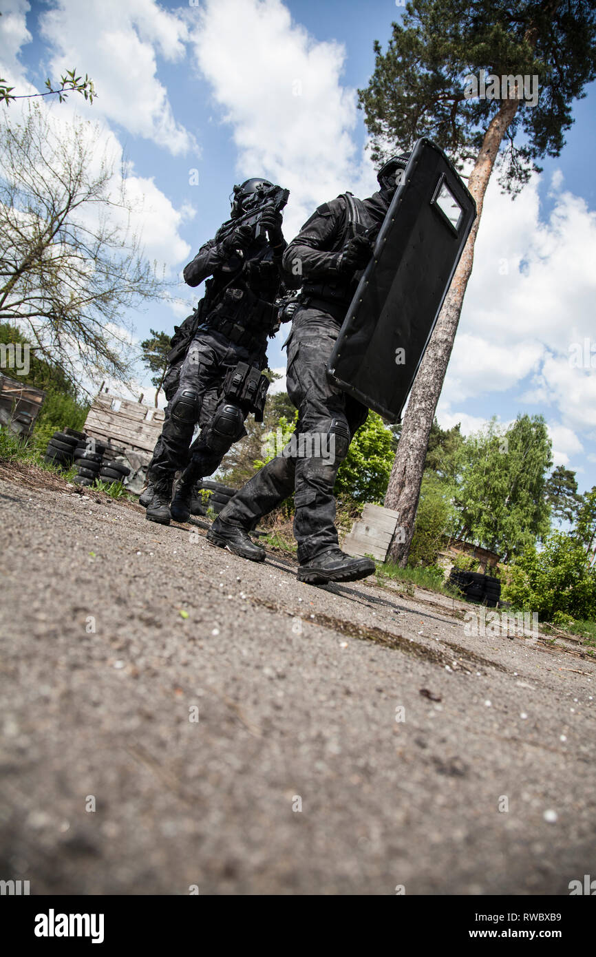 Spec ops police officers SWAT in black uniform in action Stock Photo ...