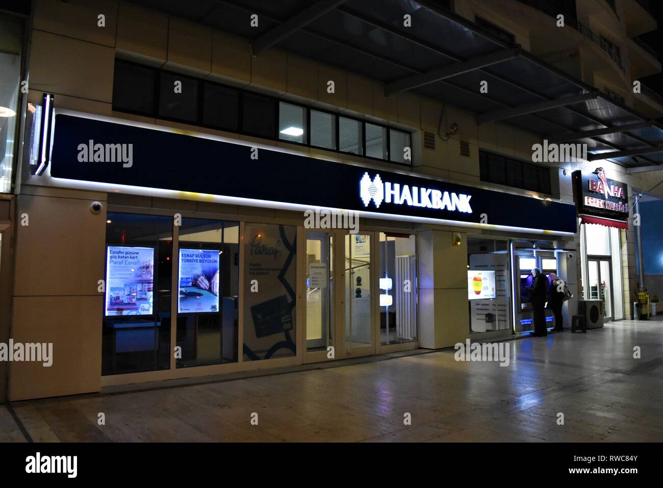 28 February 2019, Turkey, Ankara: Customers use ATM machines in front ...