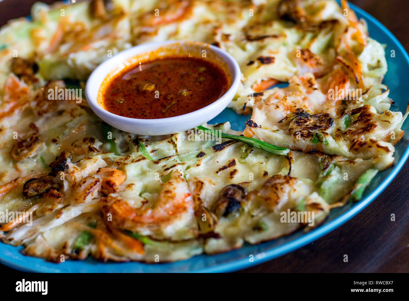 Seafood pancake with shrimp and spring onion and sauce Stock Photo - Alamy