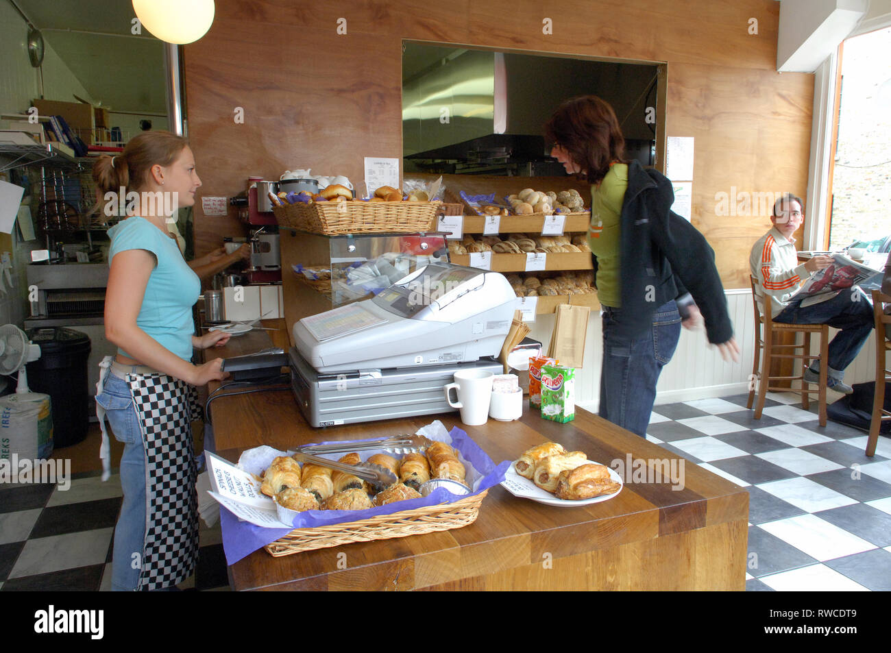 Serving a customer in a bakery, cafe Stock Photo - Alamy