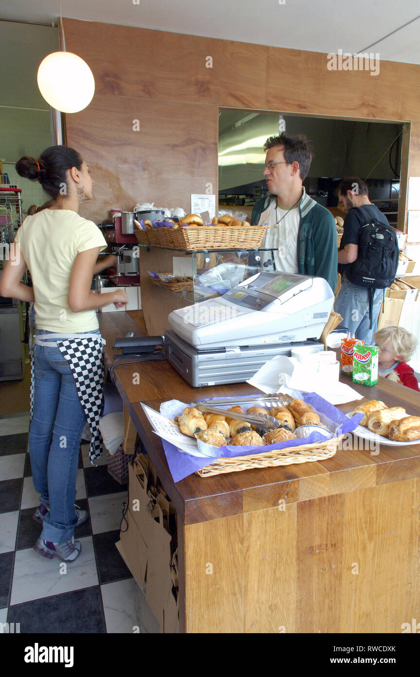 Serving a customer in a bakery, cafe Stock Photo - Alamy