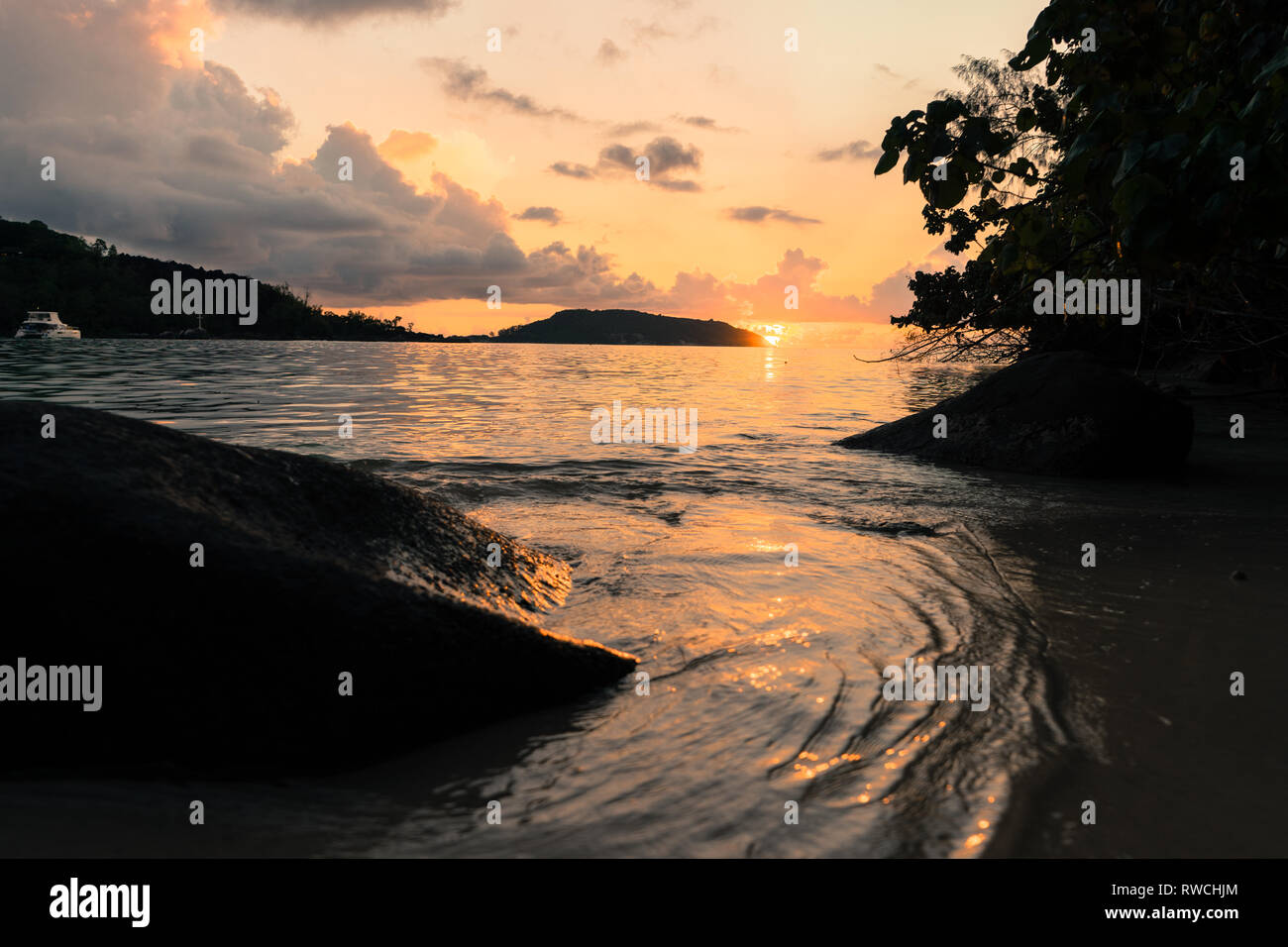 Sunset over a bay beach in Mahe Island, Seychelles Stock Photo - Alamy