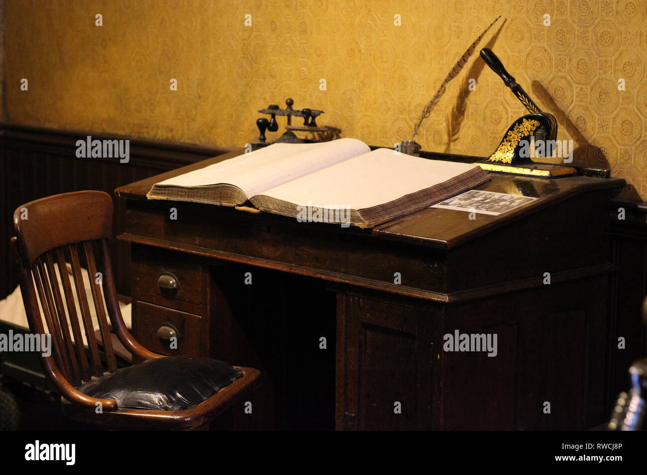 Vintage writing desk with open book and quill Stock Photo - Alamy