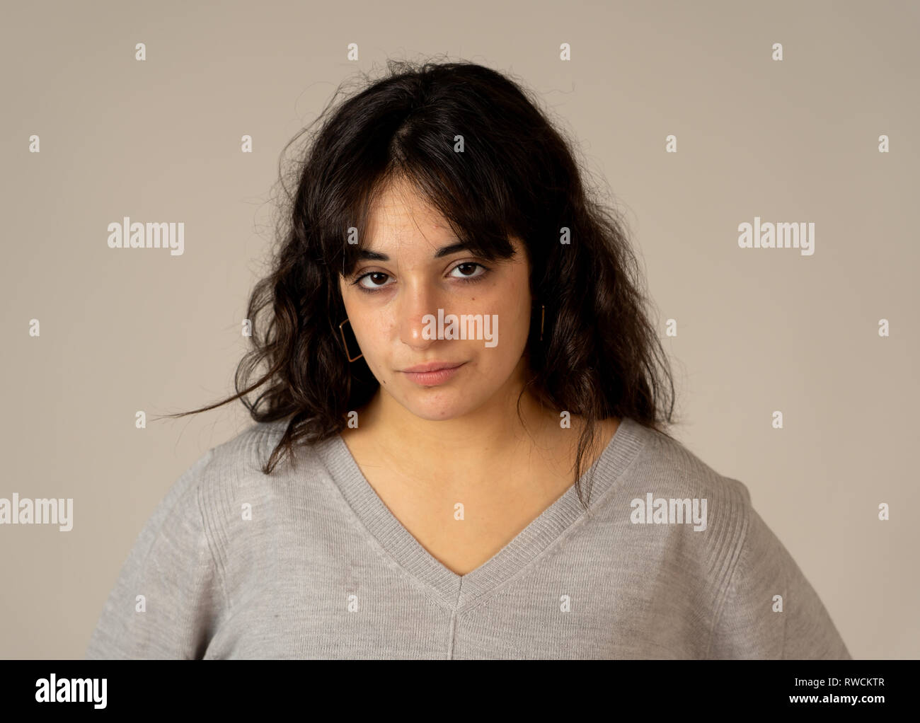 Close up portrait of beautiful young woman with sad eyes looking desperate and melancholy. Human ...
