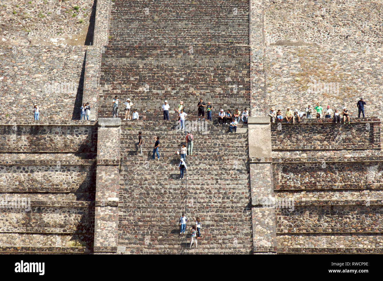 A group of tourists climbing the steep stairs on Pyramid of the Moon at ...