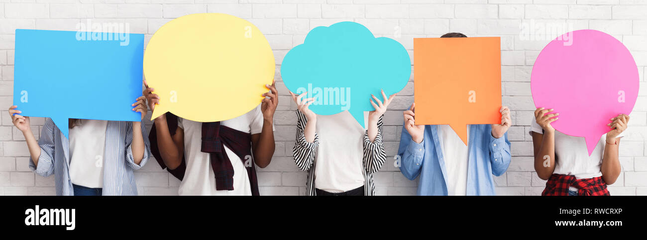 Speech bubbles. Teenagers covering faces with empty placards Stock ...