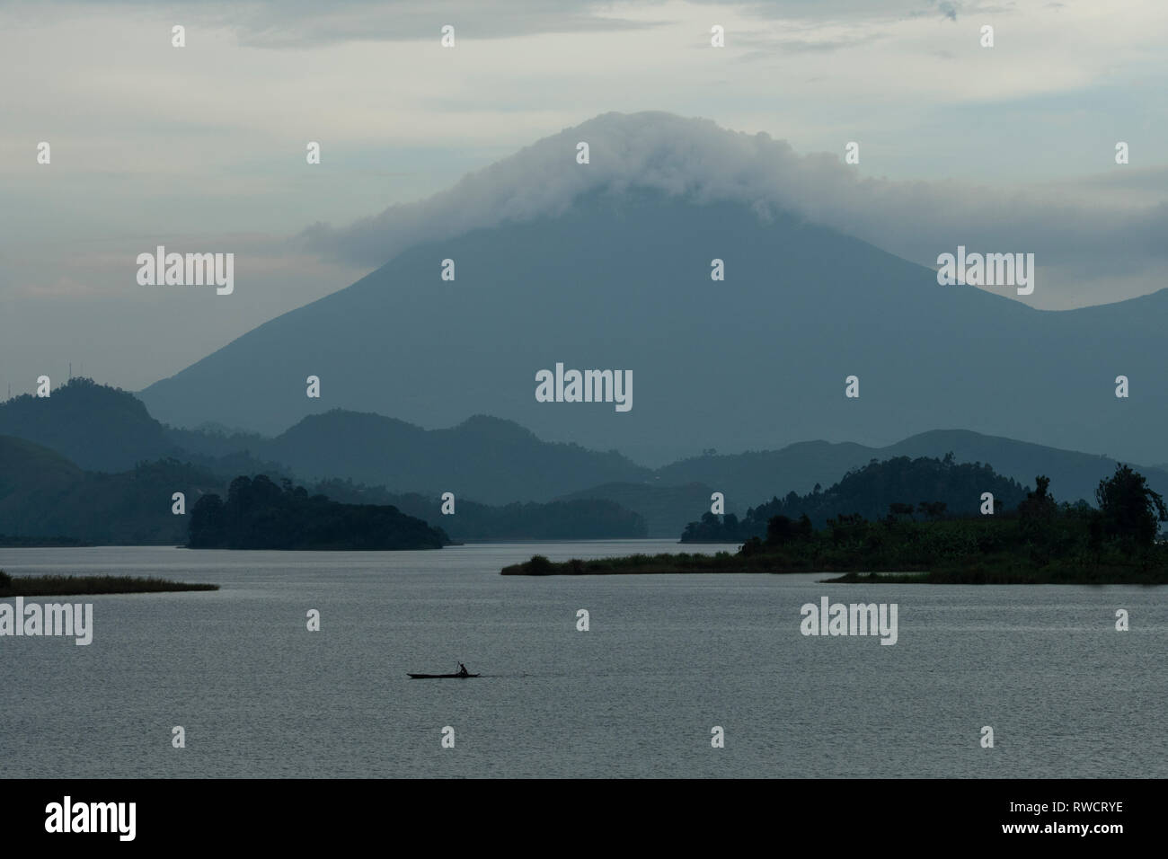 Lake Mutanda with views of volcanoes of the Virunga Mountains, Uganda ...