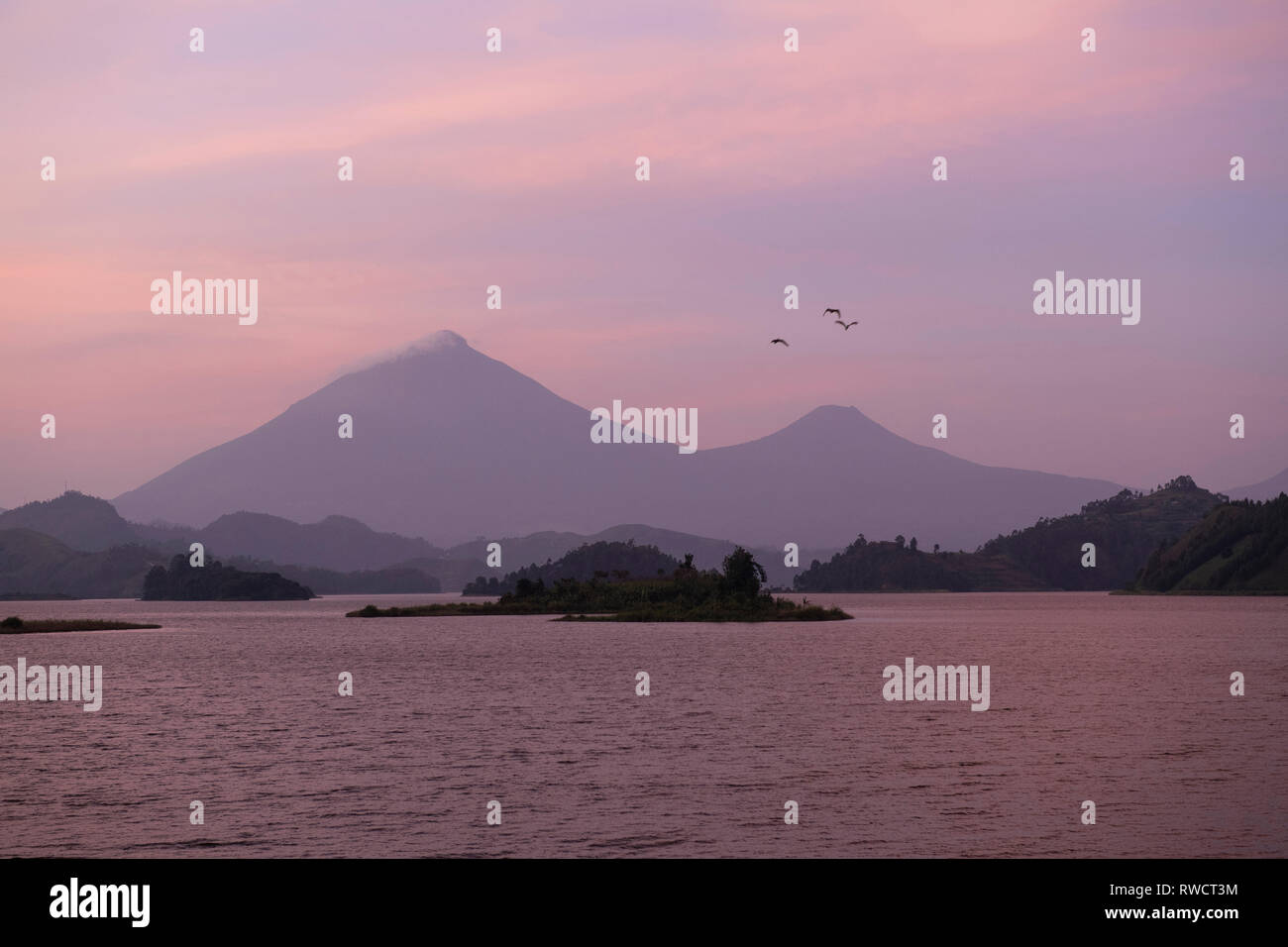 Lake Mutanda with views of volcanoes of the Virunga Mountains, Uganda ...