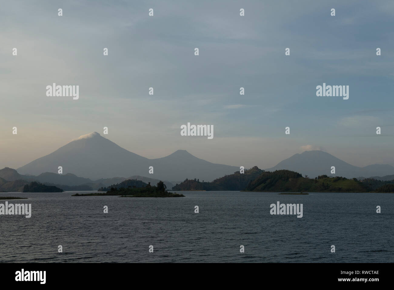 Lake Mutanda with views of volcanoes of the Virunga Mountains, Uganda ...