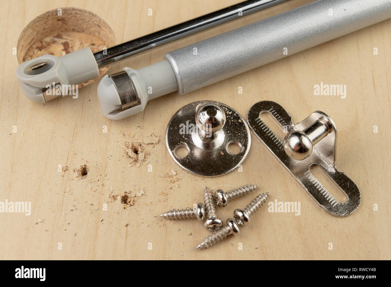 Gas lifter mounted in furniture cabinets. Small carpentry work in the ...