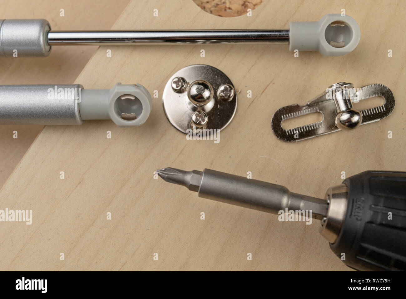 Gas lifter mounted in furniture cabinets. Small carpentry work in the ...