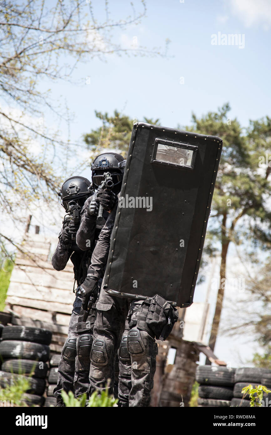 Spec ops police officers SWAT in black uniform in action Stock Photo ...