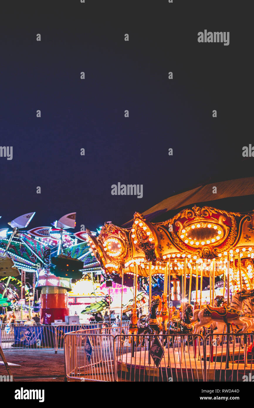 Fair Lights at night and Merry-Go-Round Stock Photo - Alamy