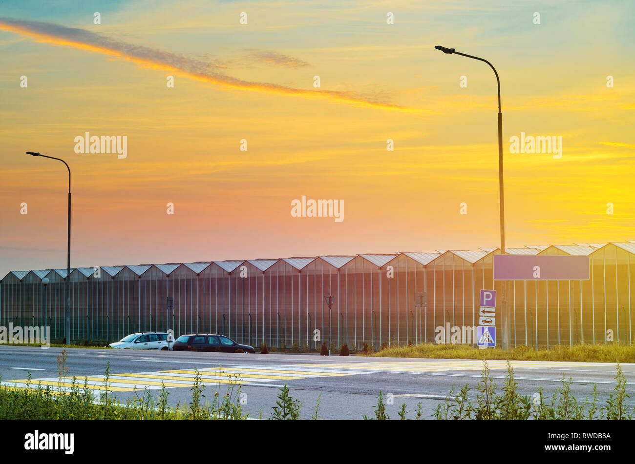 Large Industrial Greenhouse at Sunset. Gorgeous Sunset Red and Orange ...